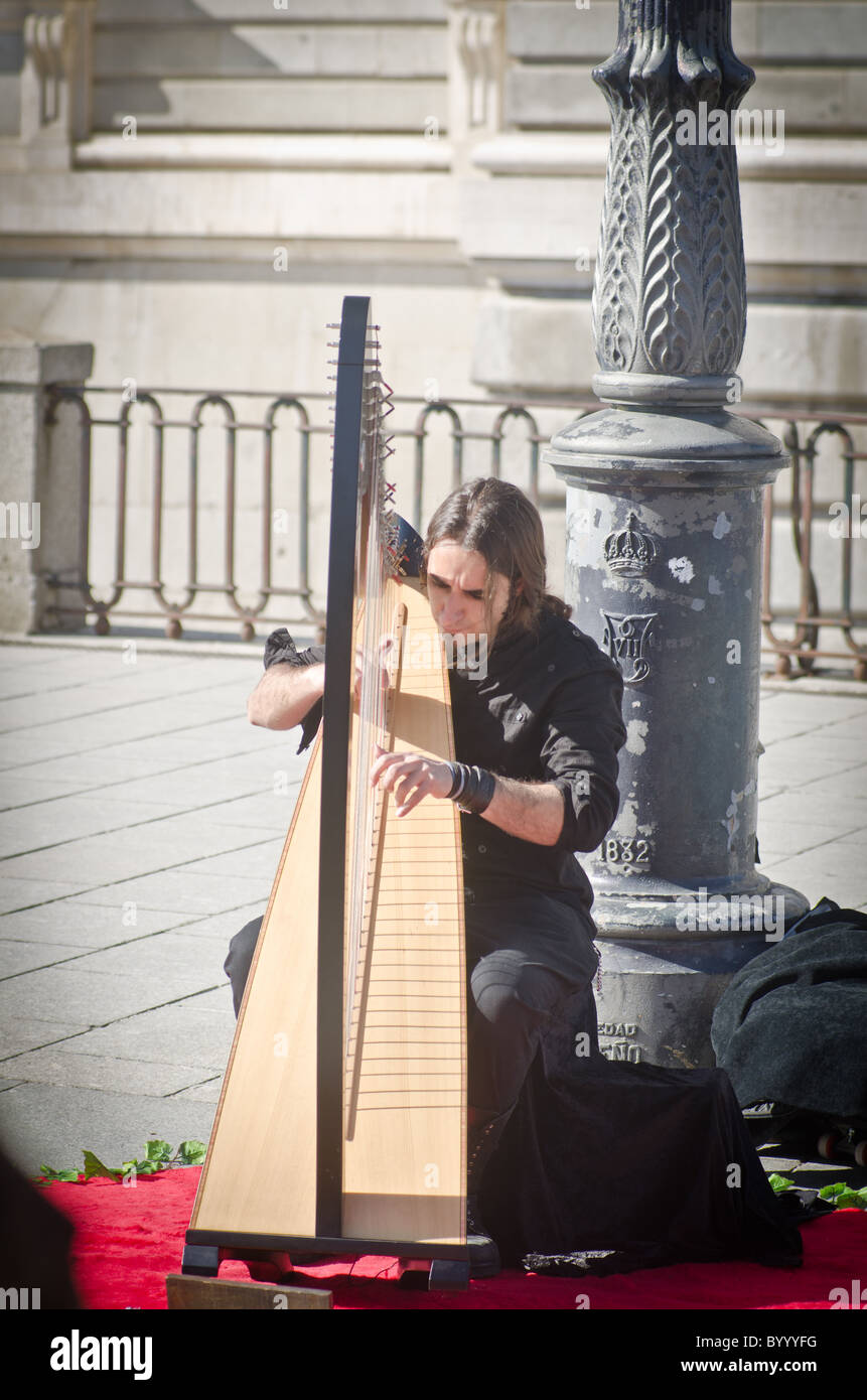 Man playing harp Stock Photo - Alamy