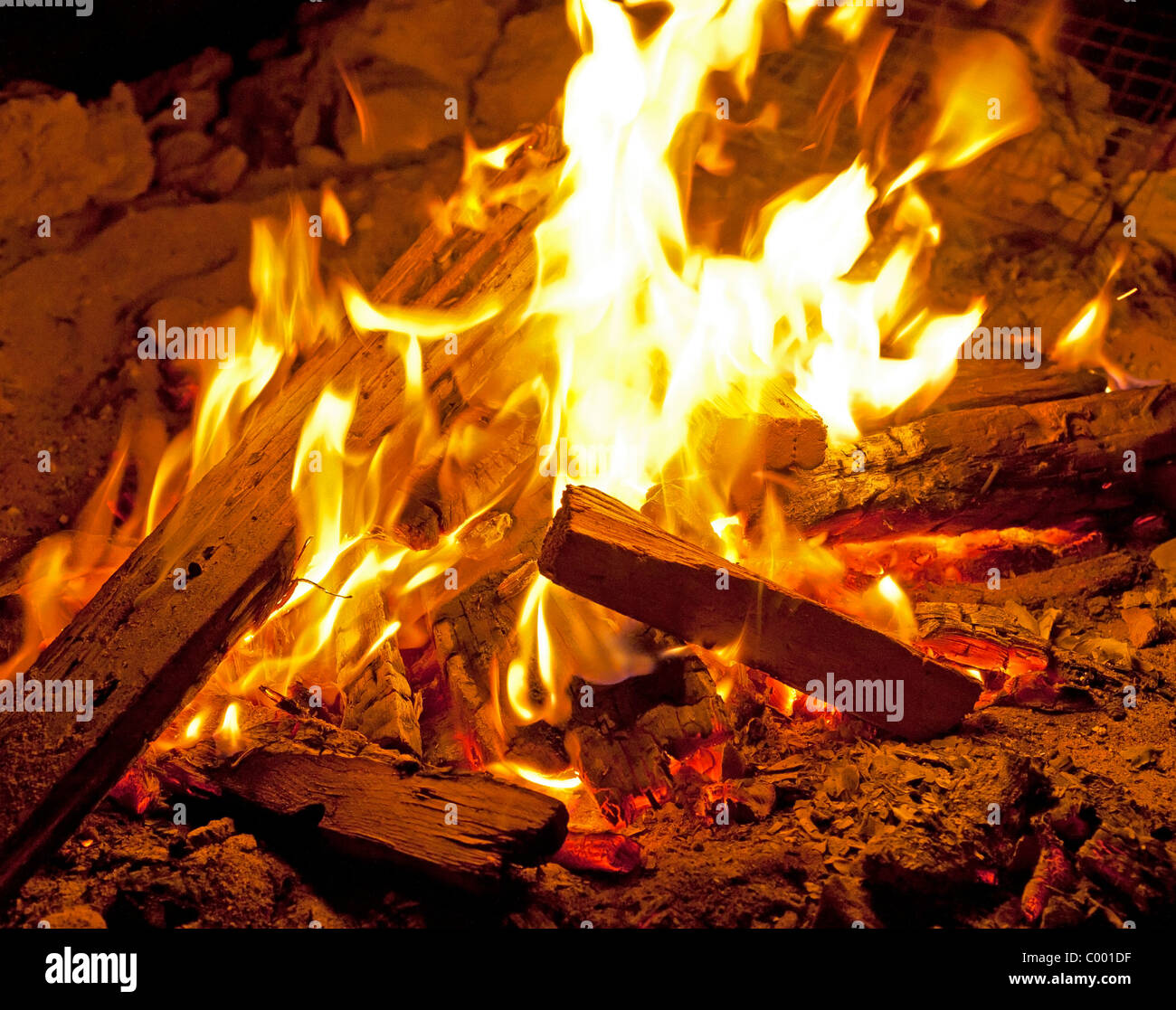 Pieces of wood burning on a campfire Stock Photo - Alamy