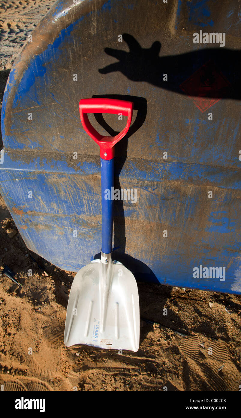 Spade and a shadow image of a hand Stock Photo - Alamy
