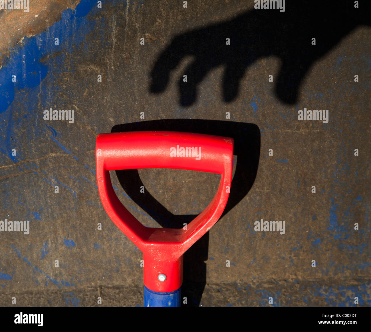 Spade and a shadow image of a hand Stock Photo - Alamy
