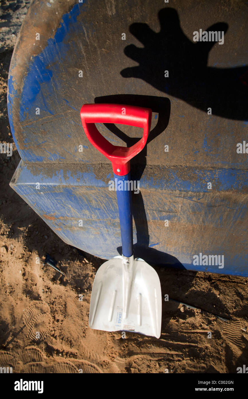 Spade and a shadow image of a hand Stock Photo - Alamy