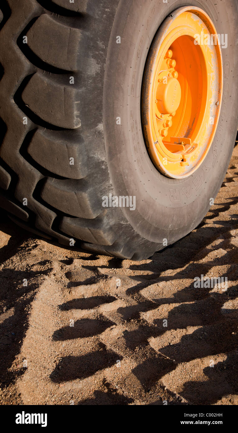 Front loader tyre and yellow wheel rim Stock Photo - Alamy