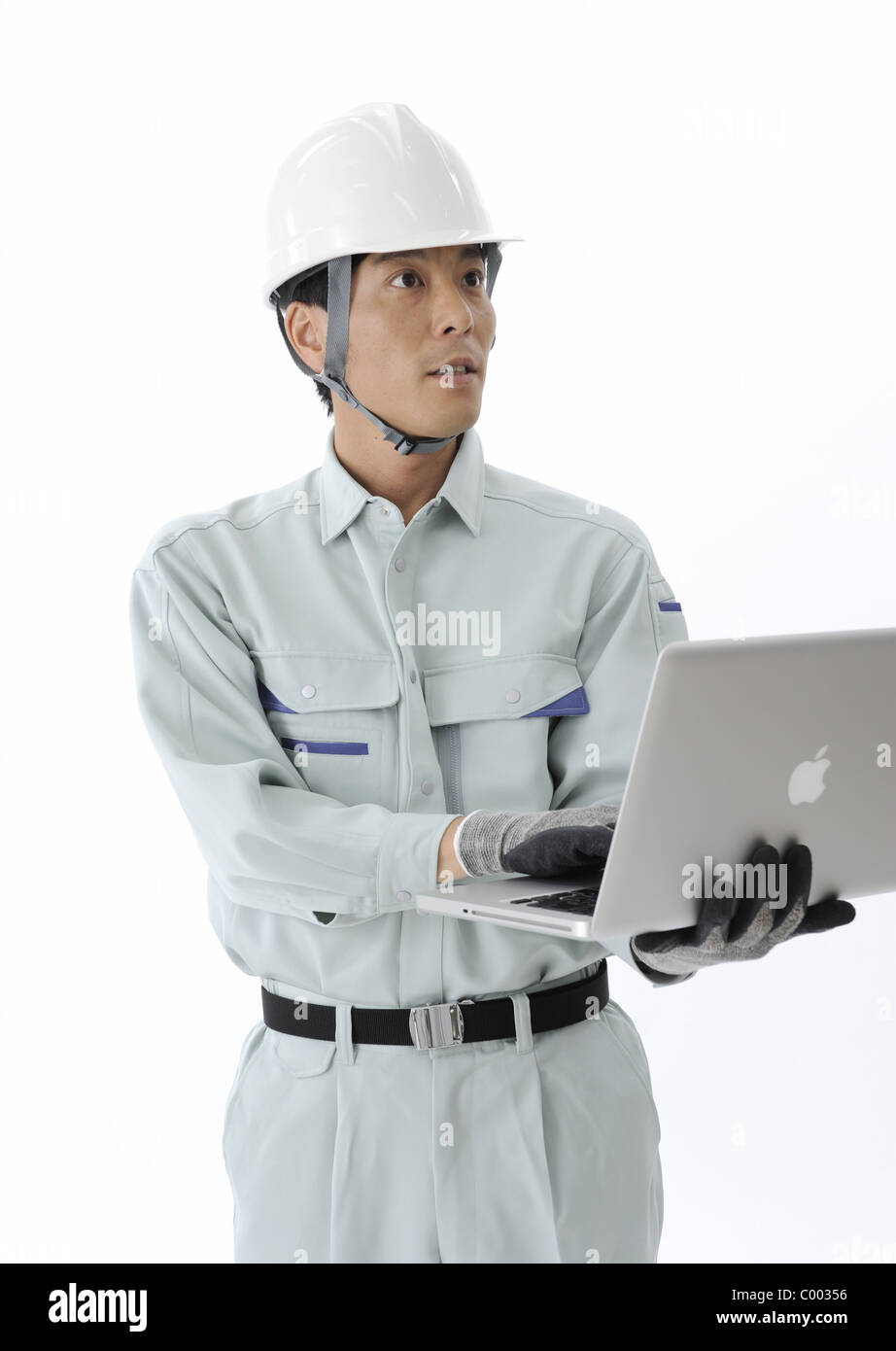 Construction worker working on laptop Stock Photo - Alamy