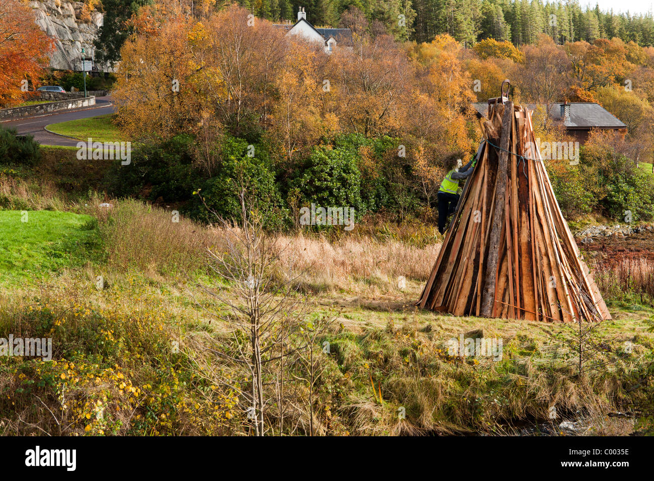 Stack of wood in the shape of a bonfire with a 'doll' climbing up its ...