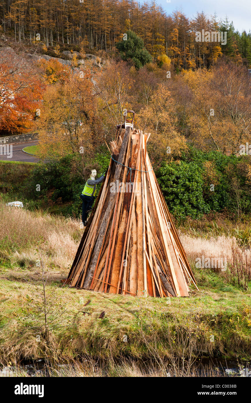Stack of wood in the shape of a bonfire with a 'doll' climbing up its ...