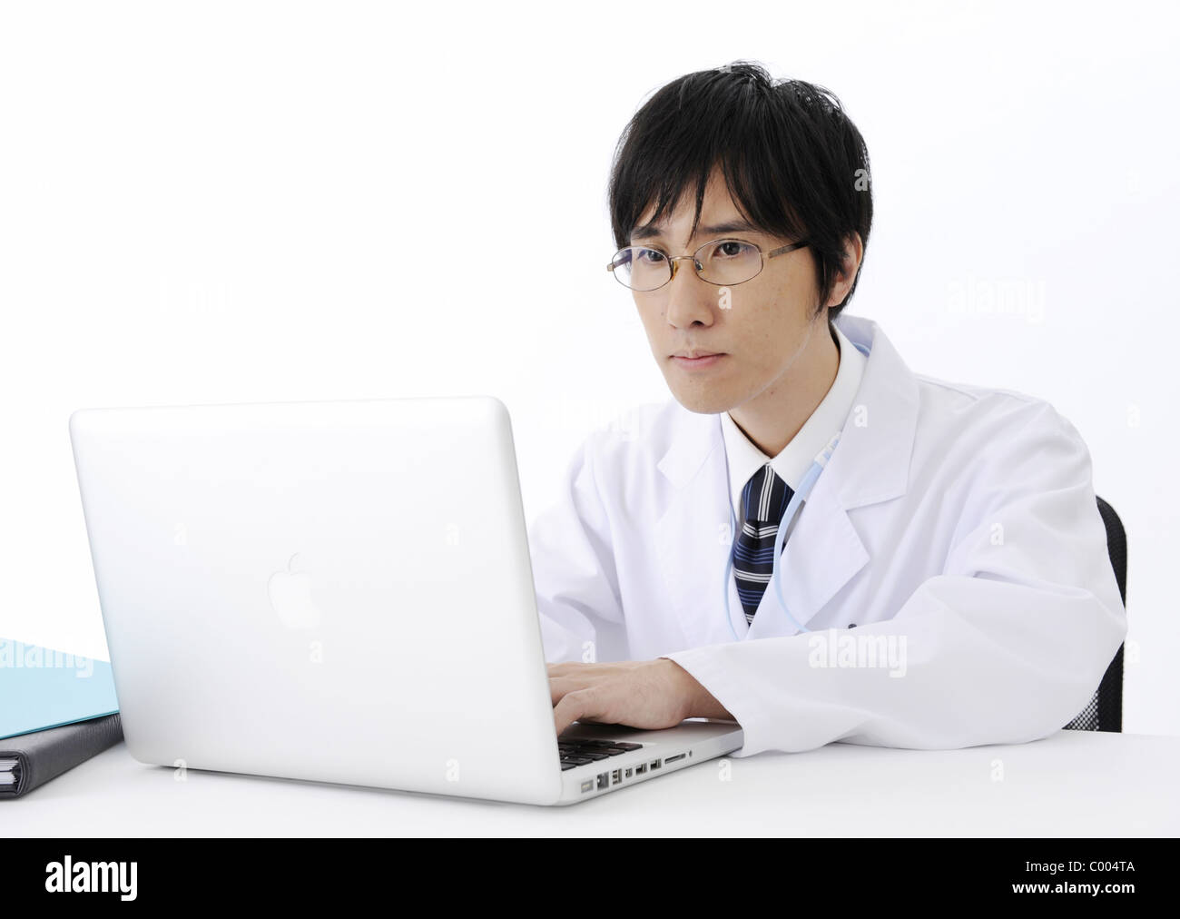 Lab worker working on laptop Stock Photo - Alamy