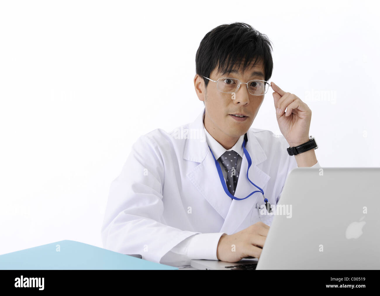 Lab worker working on laptop Stock Photo - Alamy