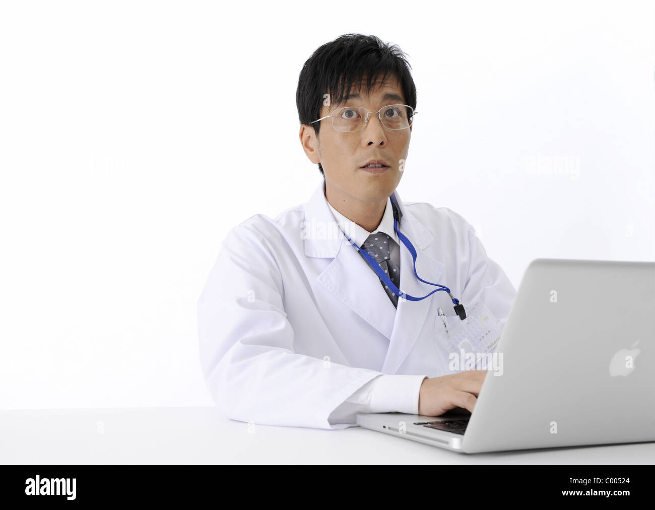 Lab worker working on laptop Stock Photo - Alamy