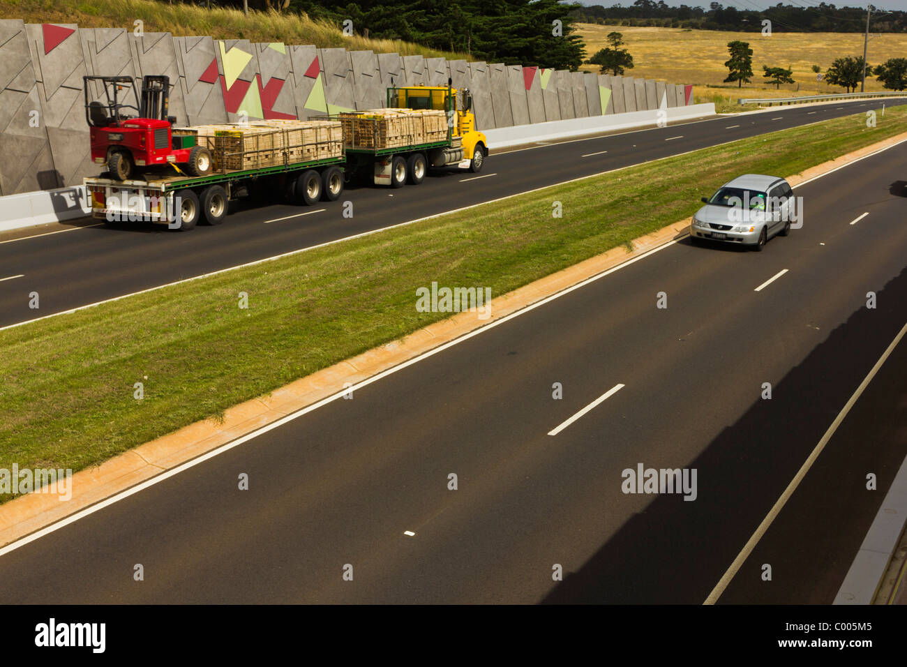 Traffic passing through new road cutting Stock Photo - Alamy