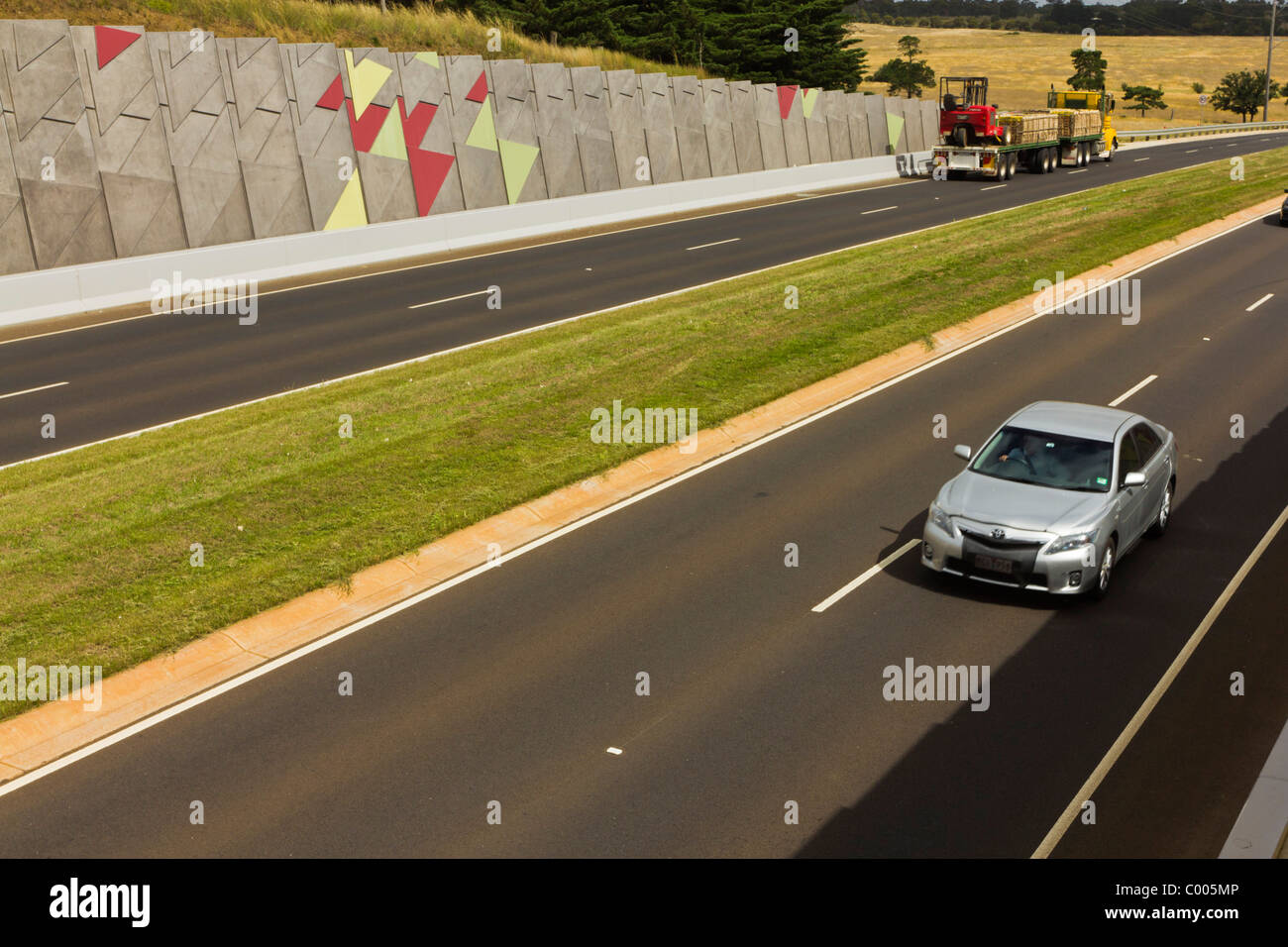 Traffic passing through new road cutting Stock Photo - Alamy