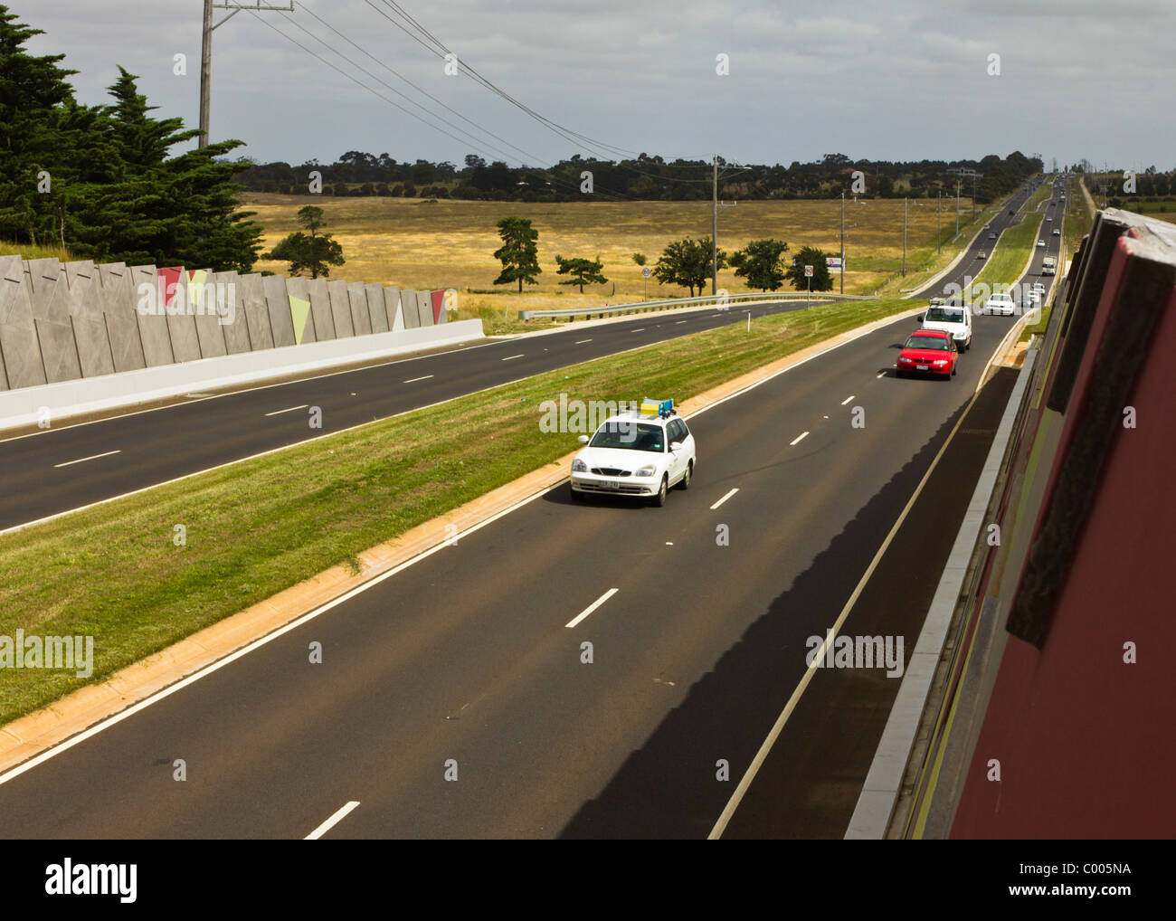 Traffic passing through new road cutting Stock Photo - Alamy