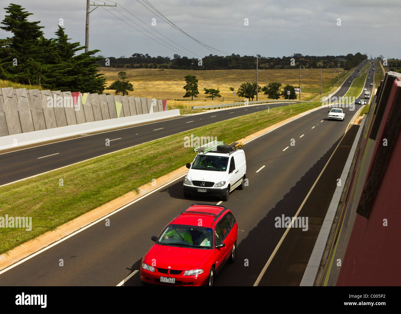 Traffic passing through new road cutting Stock Photo - Alamy