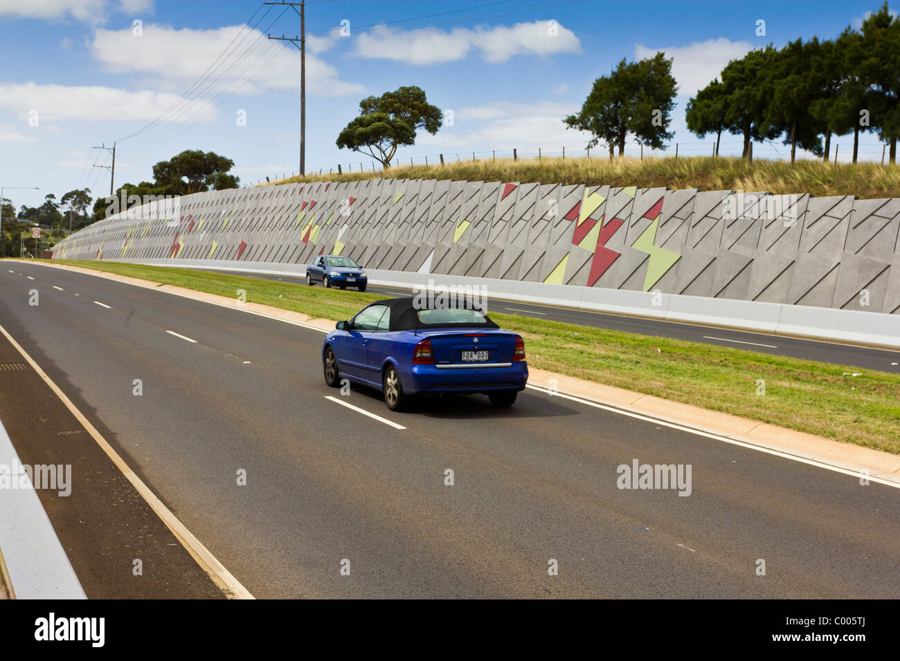 Traffic passing through new road cutting Stock Photo - Alamy