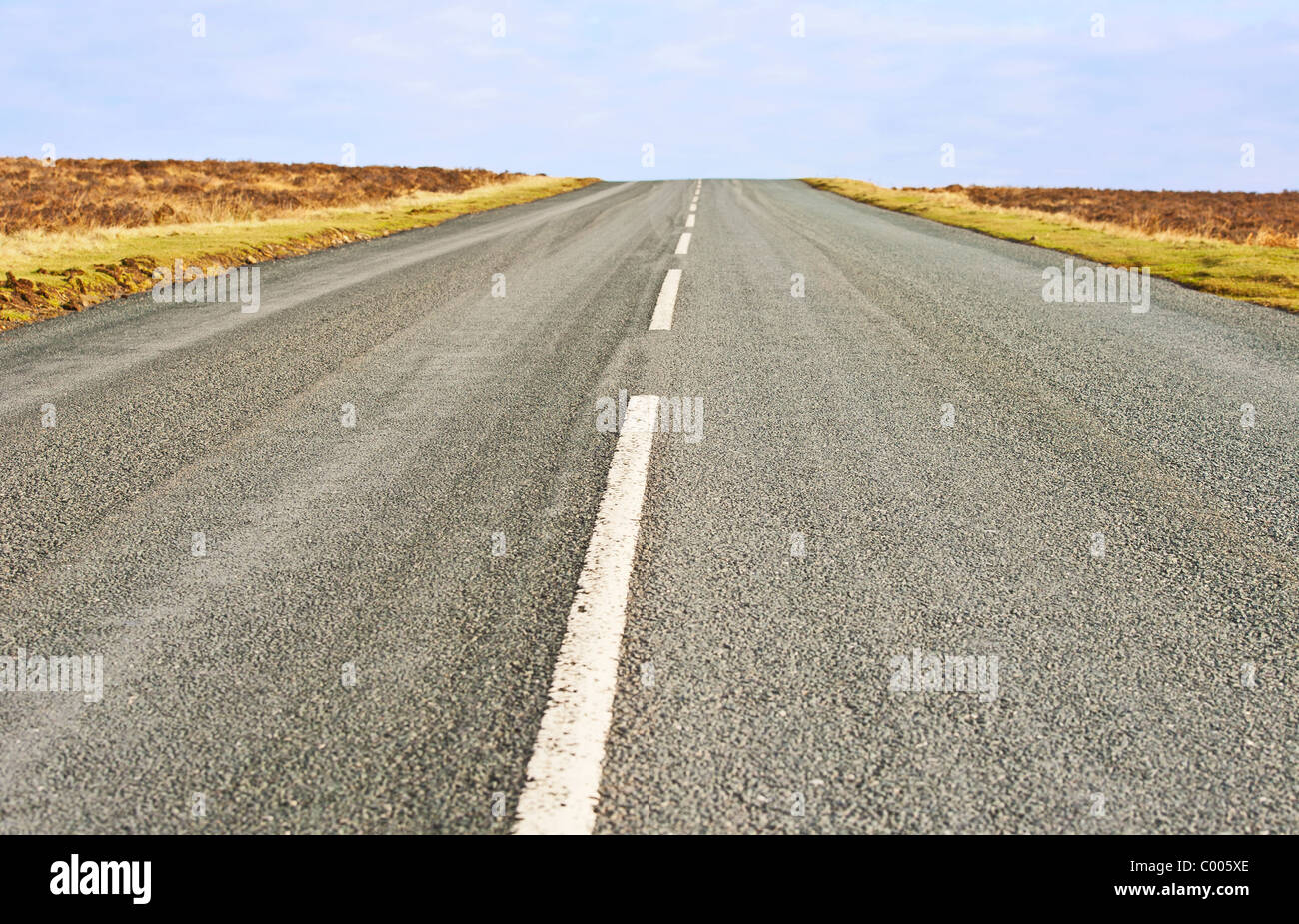 Single lane road in the countryside heading towards horizon Stock Photo ...