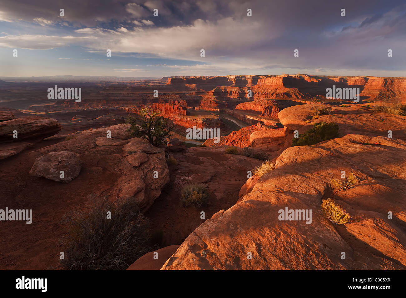 Morning sunrise light skims the red slick rock at Dead Horse Point ...