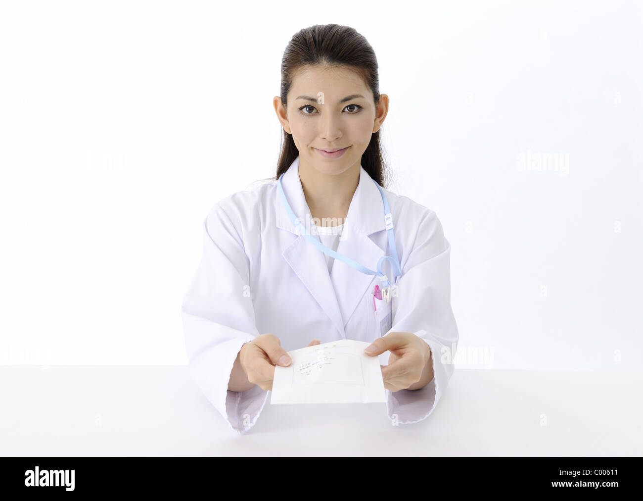 Pharmacist holding out an envelope for drug Stock Photo - Alamy