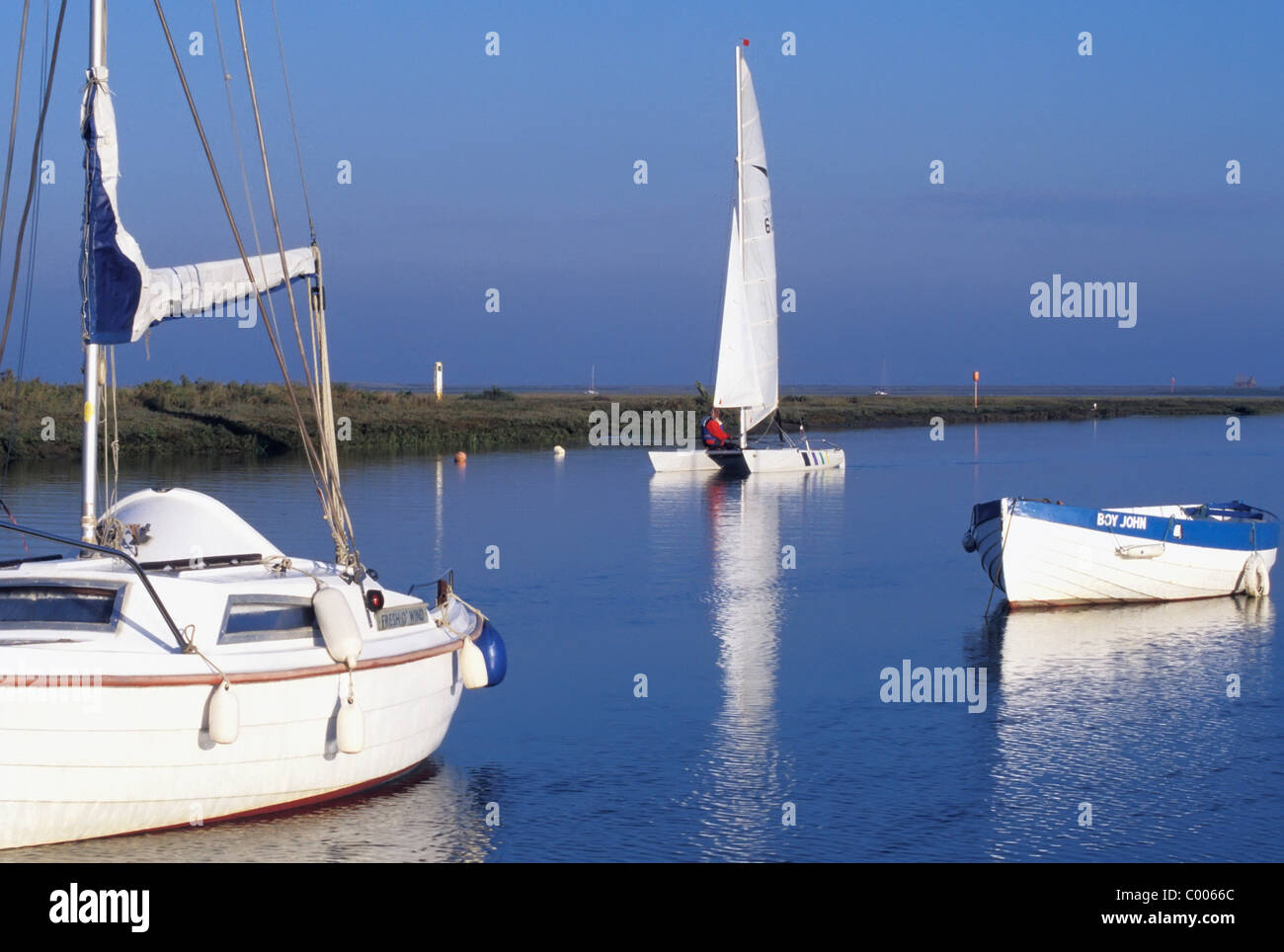 Boats On Still River Stock Photo - Alamy