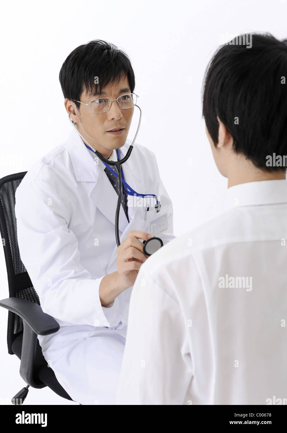 Doctor examining patient Stock Photo - Alamy