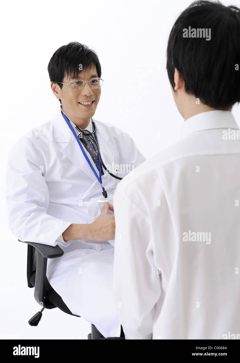 Doctor examining patient Stock Photo - Alamy
