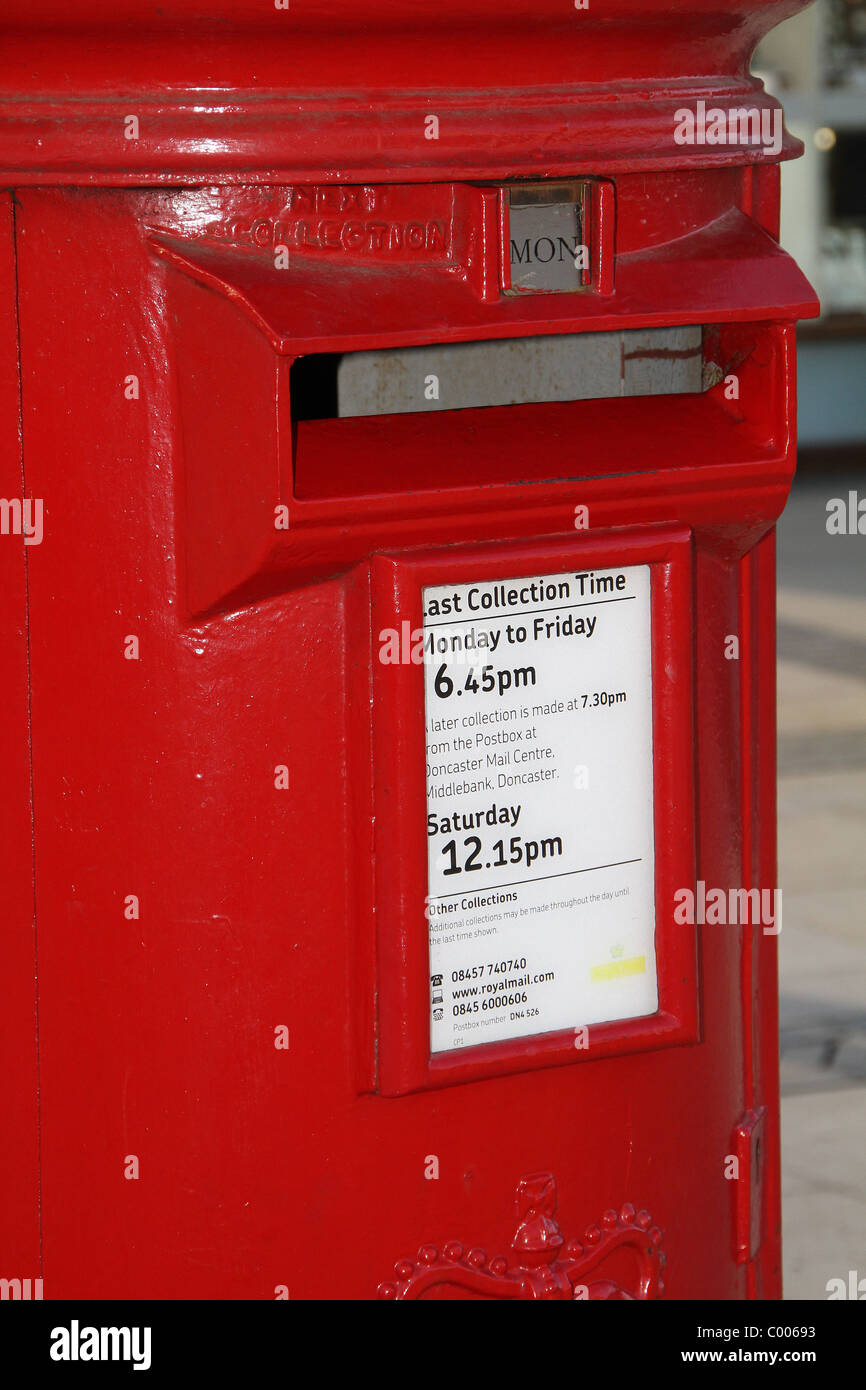 Red post box with collection time display Stock Photo - Alamy