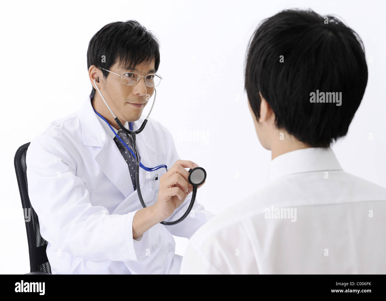Doctor examining patient hi-res stock photography and images - Alamy
