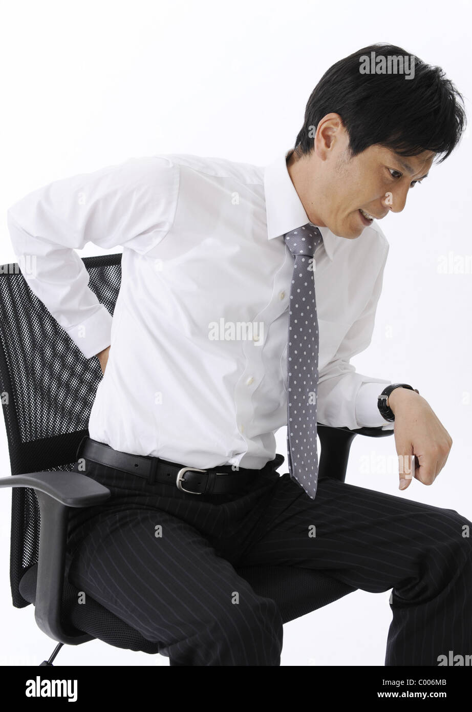 Businessman putting hand on his back Stock Photo - Alamy