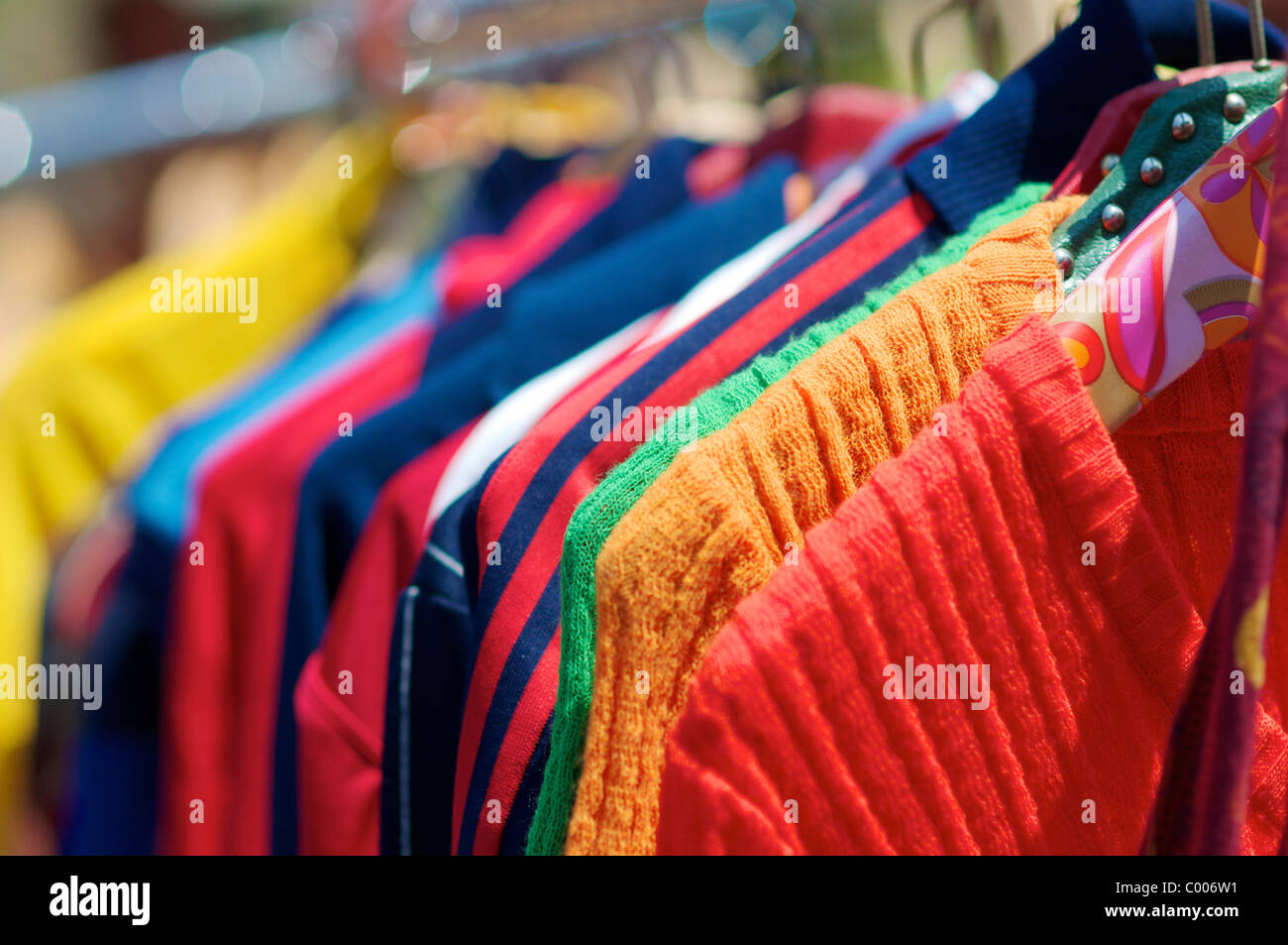 Colorful second hand clothing on a cloth rack on a market during a ...