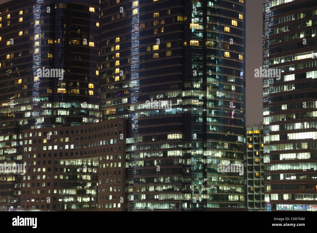 Highrise office buildgins illuminated at night Stock Photo - Alamy