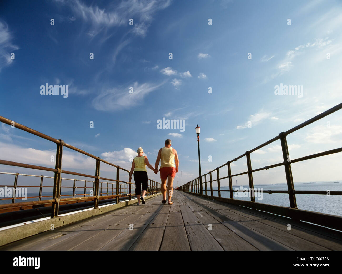 Couple Walking Down Pier Stock Photo - Alamy