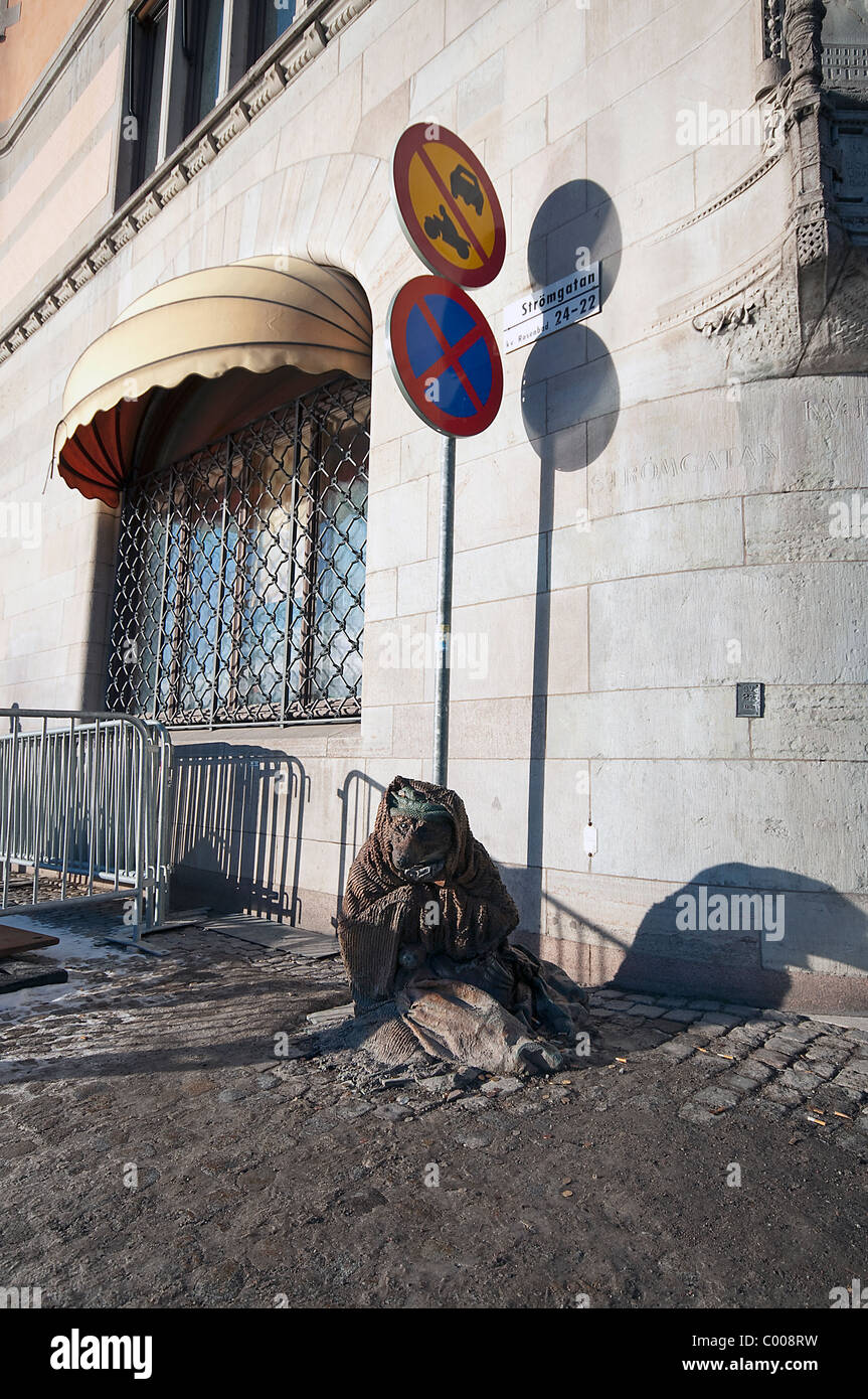 Street statue sitting on pavement under road sign in Stockholm Sweden ...