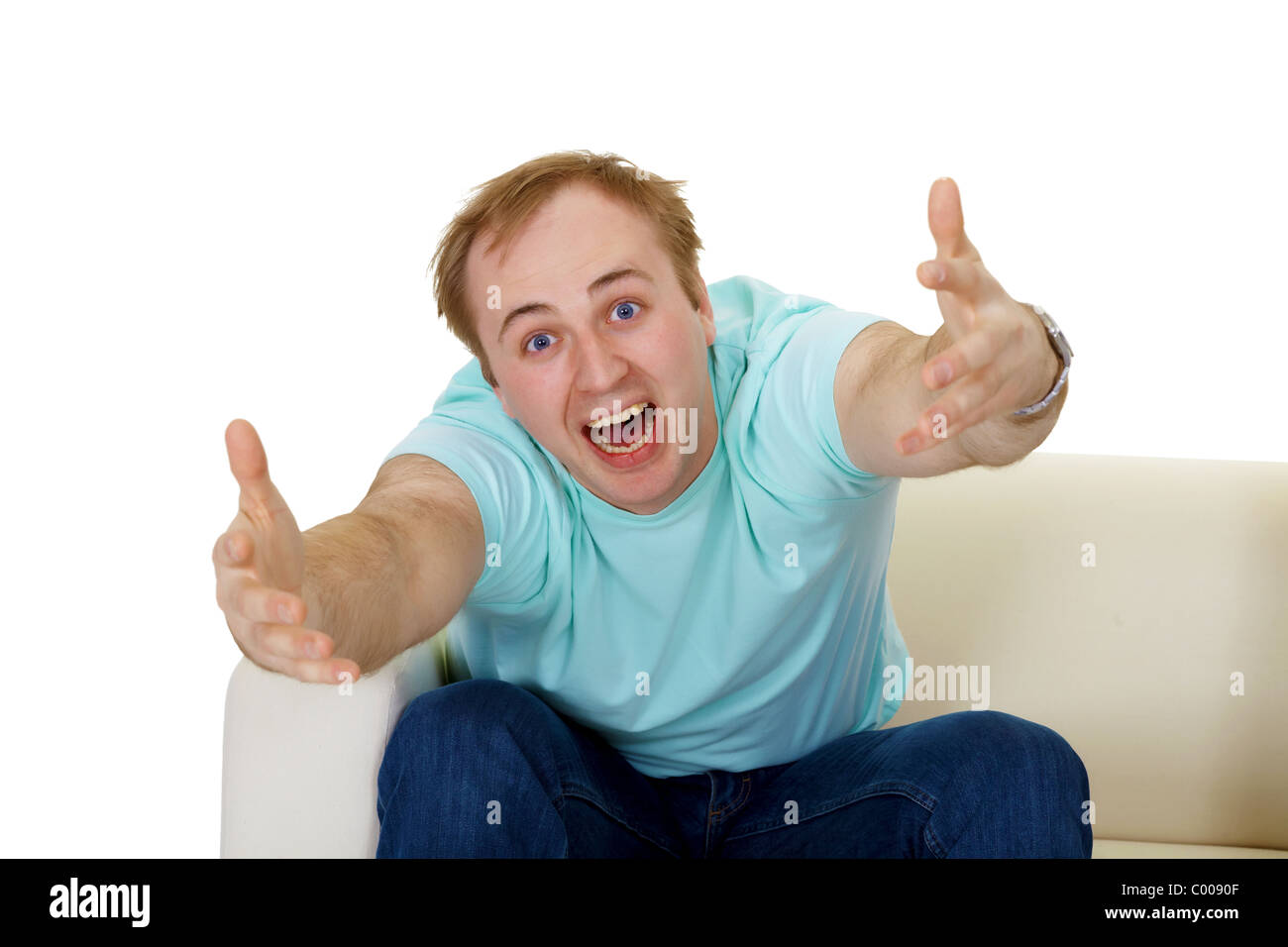 emotional man shouting, gesticulating, sitting on the couch. isolated ...