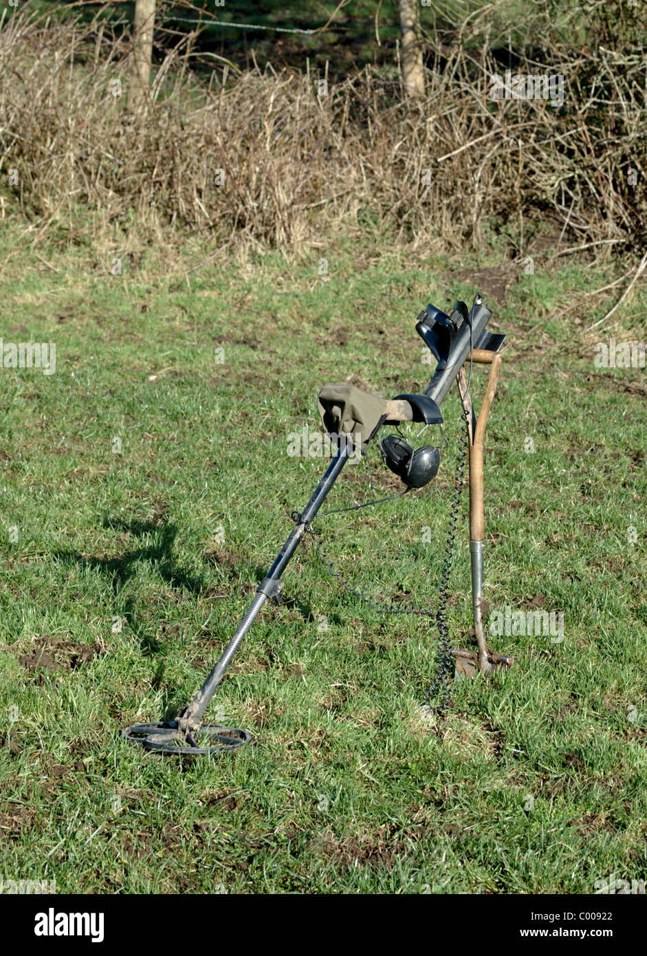 Metal detector resting on spade in field Stock Photo - Alamy