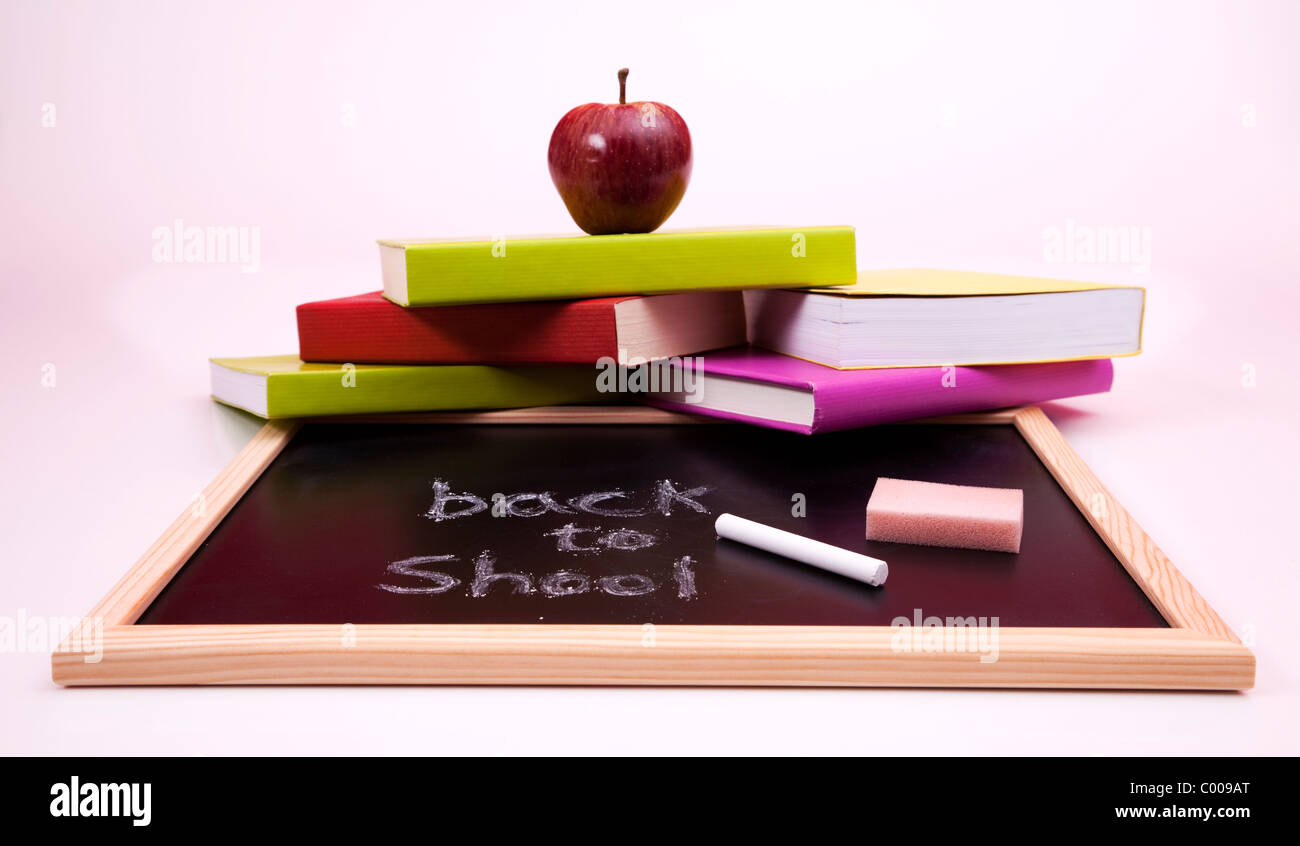Back to school letters written on a blackboard with colorful books ...