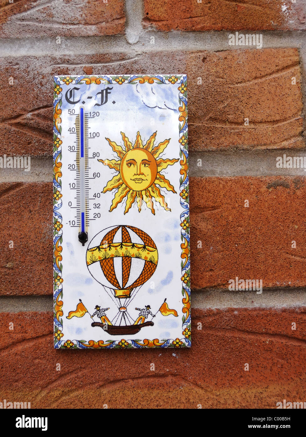 Broken Ceramic thermometer on a brick wall Stock Photo - Alamy