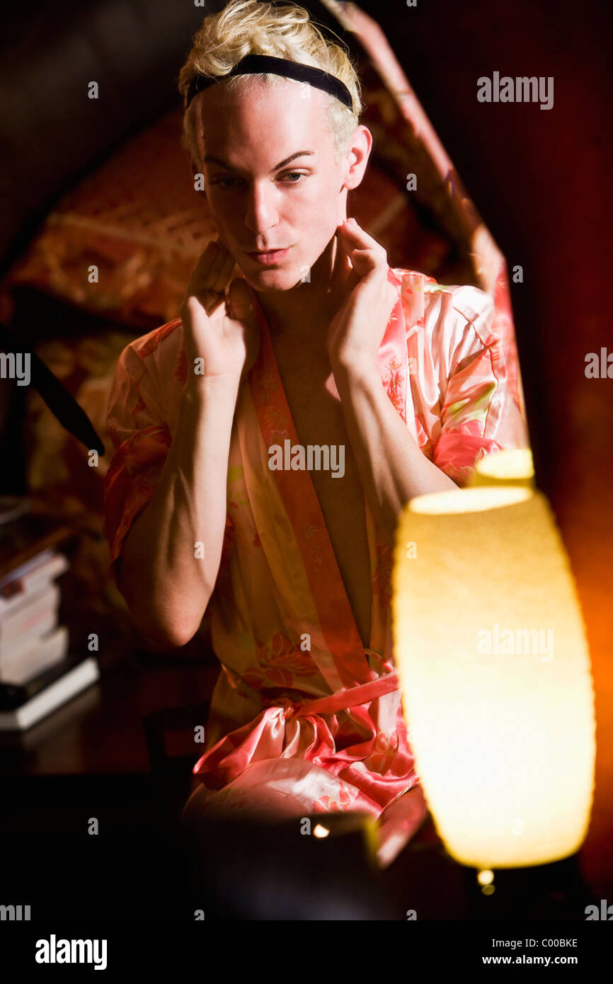 Drag queen looking in mirror at night Stock Photo - Alamy