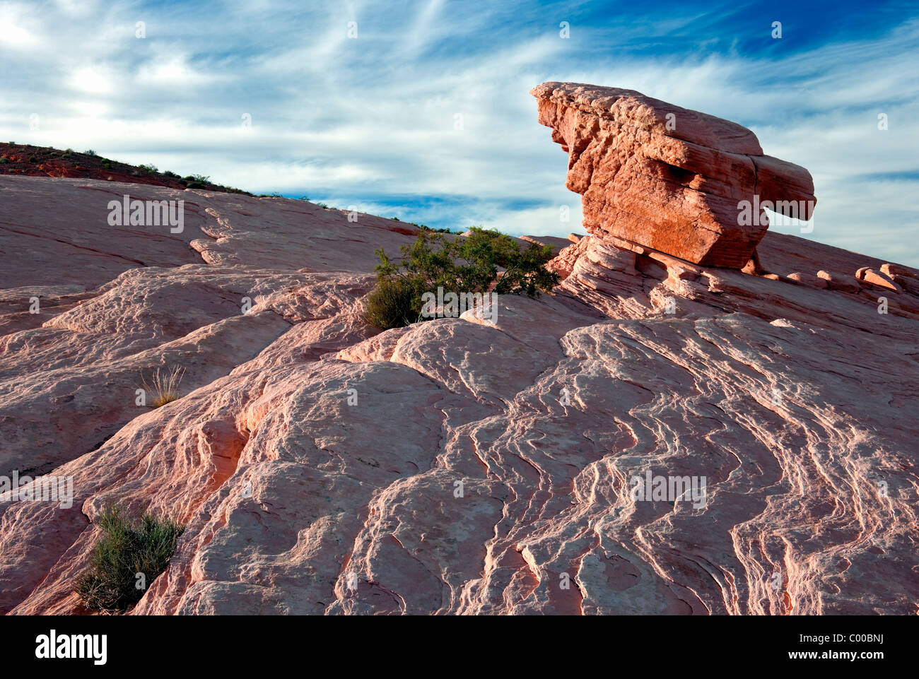 A lone balancing rock sits atop this sandstone plateau in Nevada's ...