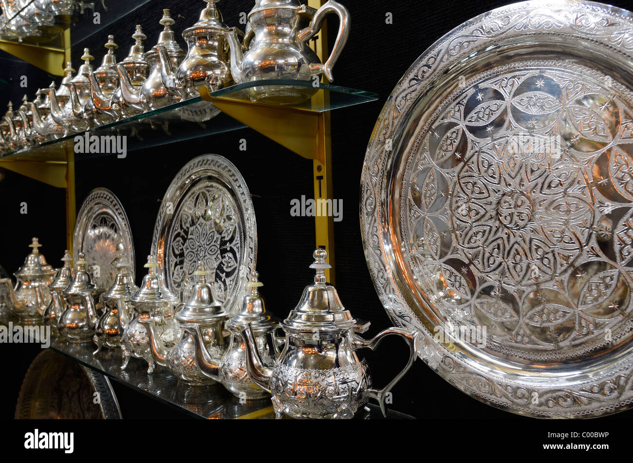 Metalware shop with silver teapots and plates with intricate design ...