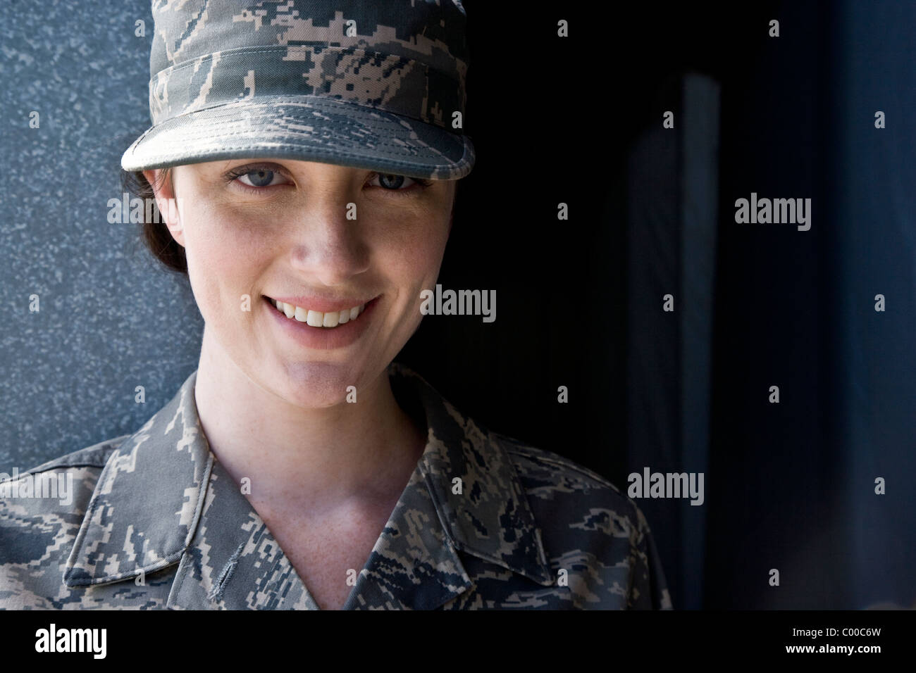 Smiling young woman in army combat uniform Stock Photo - Alamy