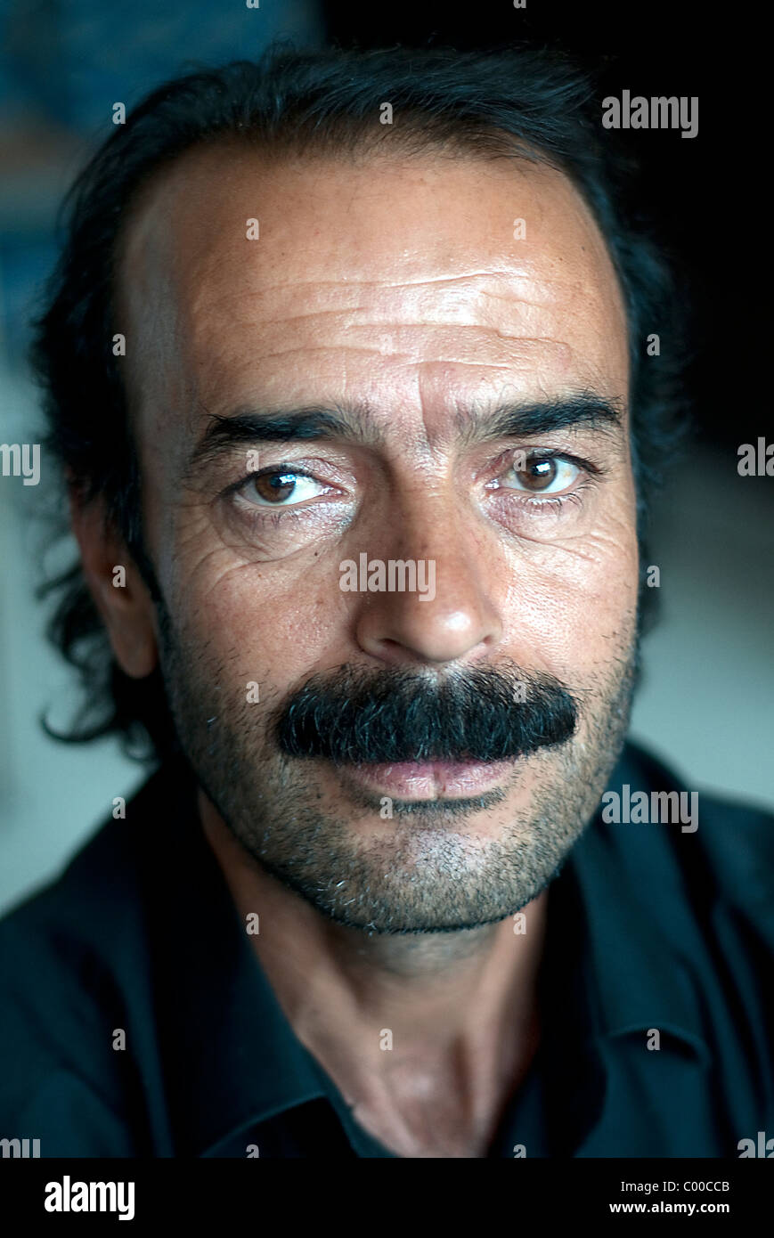 A portrait of a Kurdish man with a bushy moustache living in the city ...