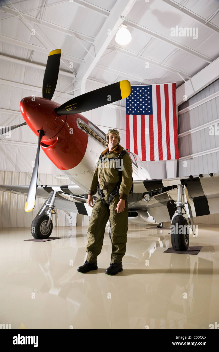 Pilot with vintage fighter plane in hangar Stock Photo - Alamy