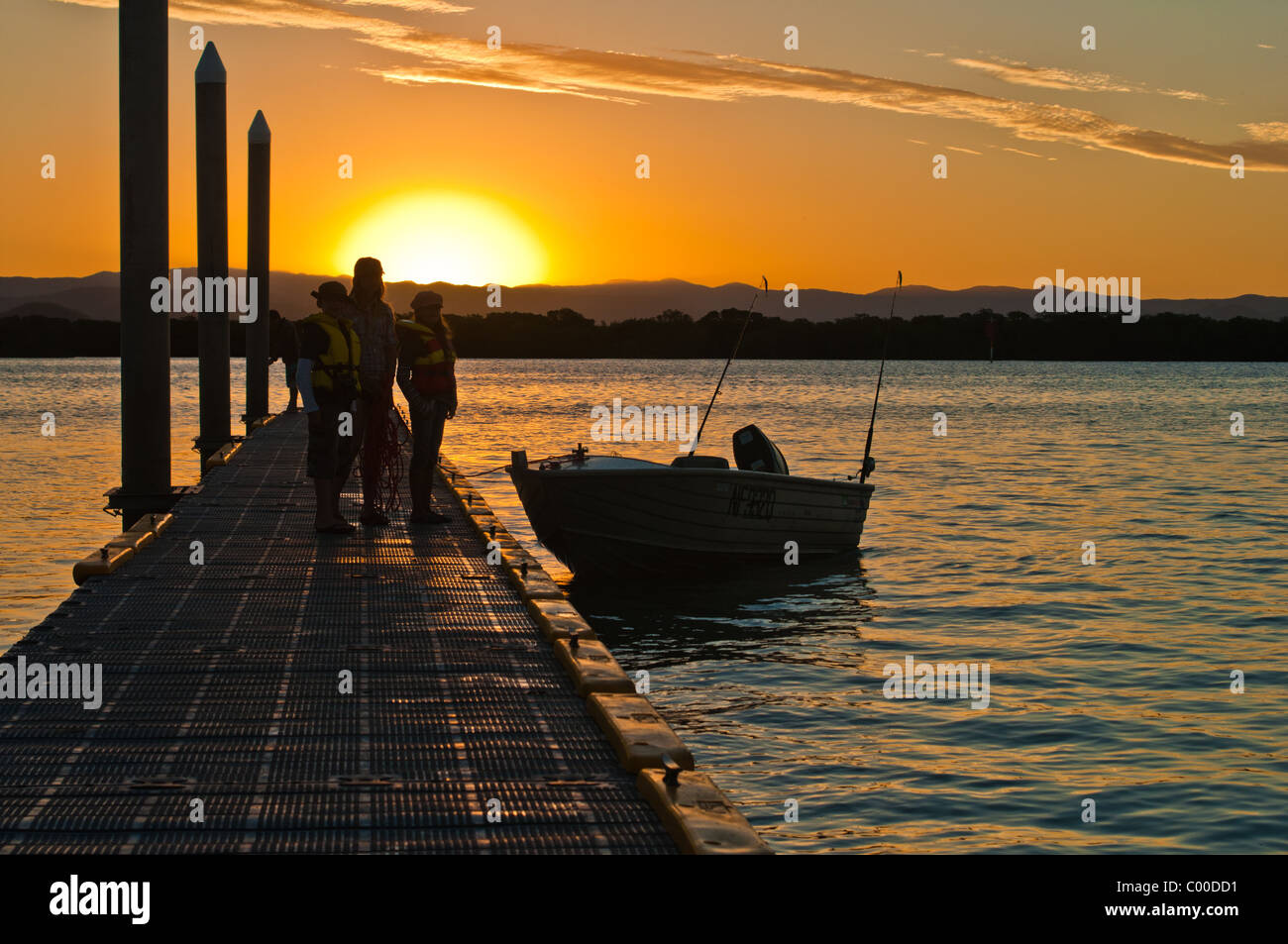 Boat and jetty sunset Stock Photo - Alamy