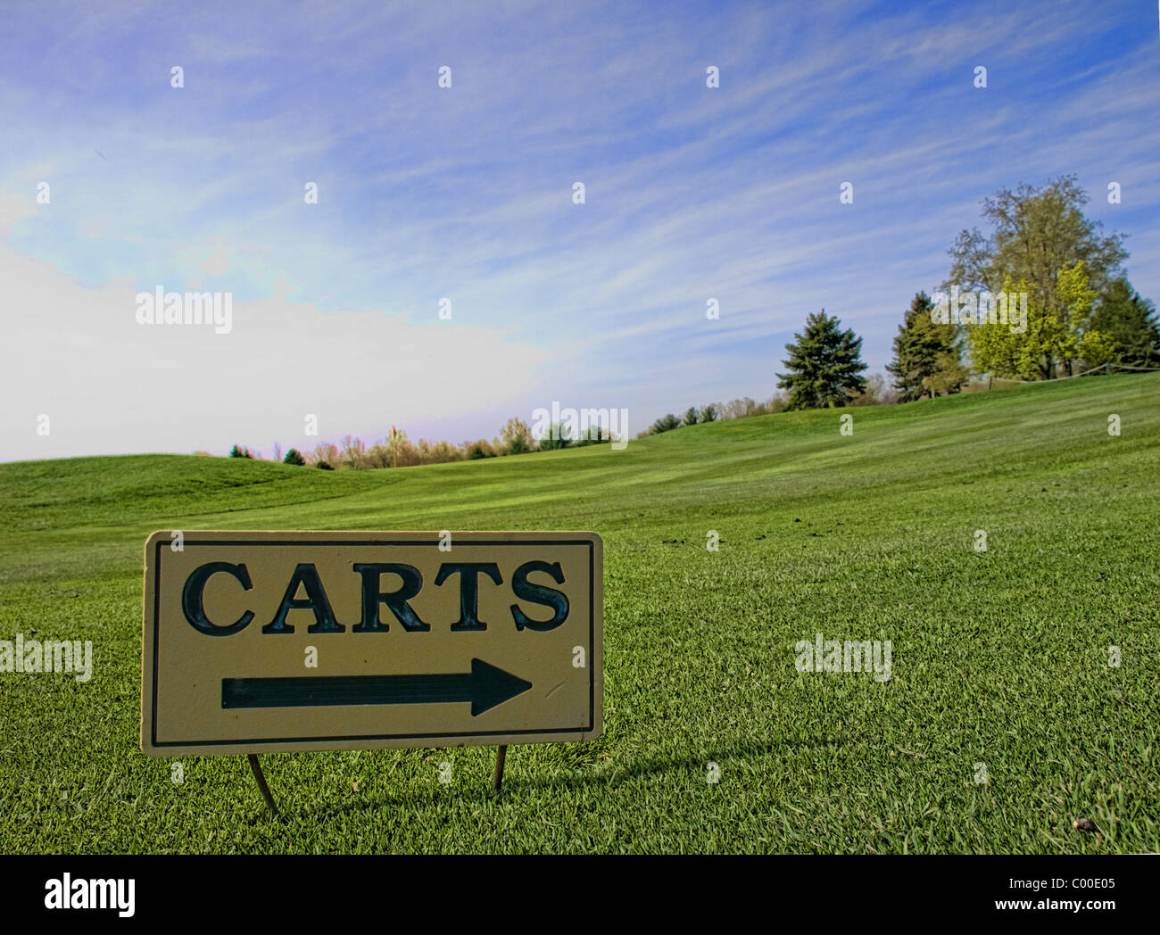 Golf course with sign stating carts this way Stock Photo - Alamy