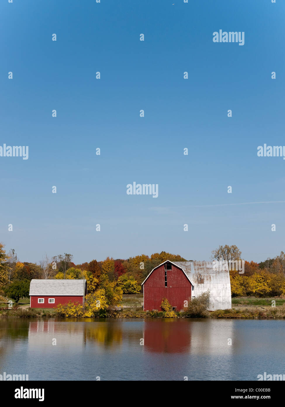 Old farm buildings with red barn along shores of Mott Lake at ...