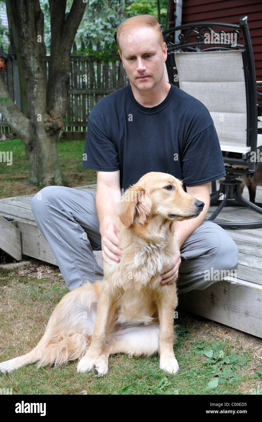 Man with Golden Retriever dog Stock Photo - Alamy