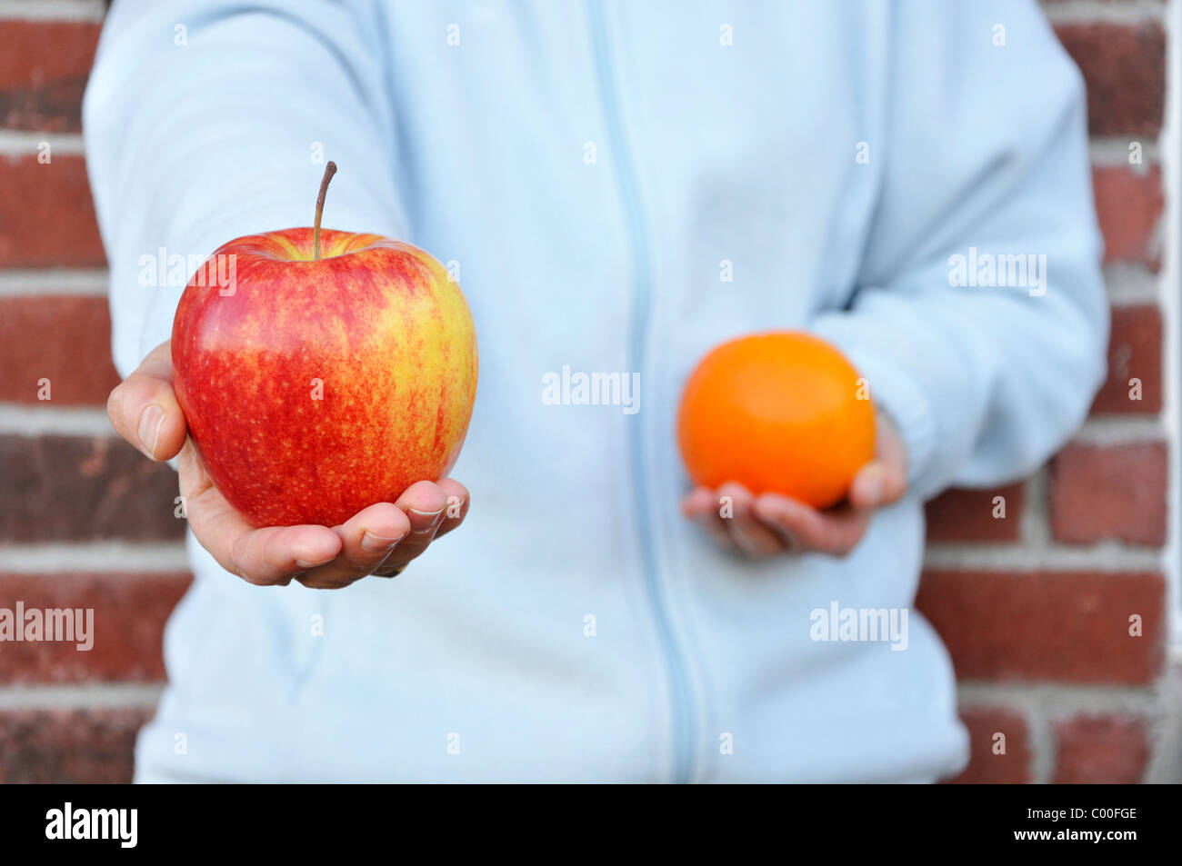 Apples and oranges comparison concept Stock Photo - Alamy
