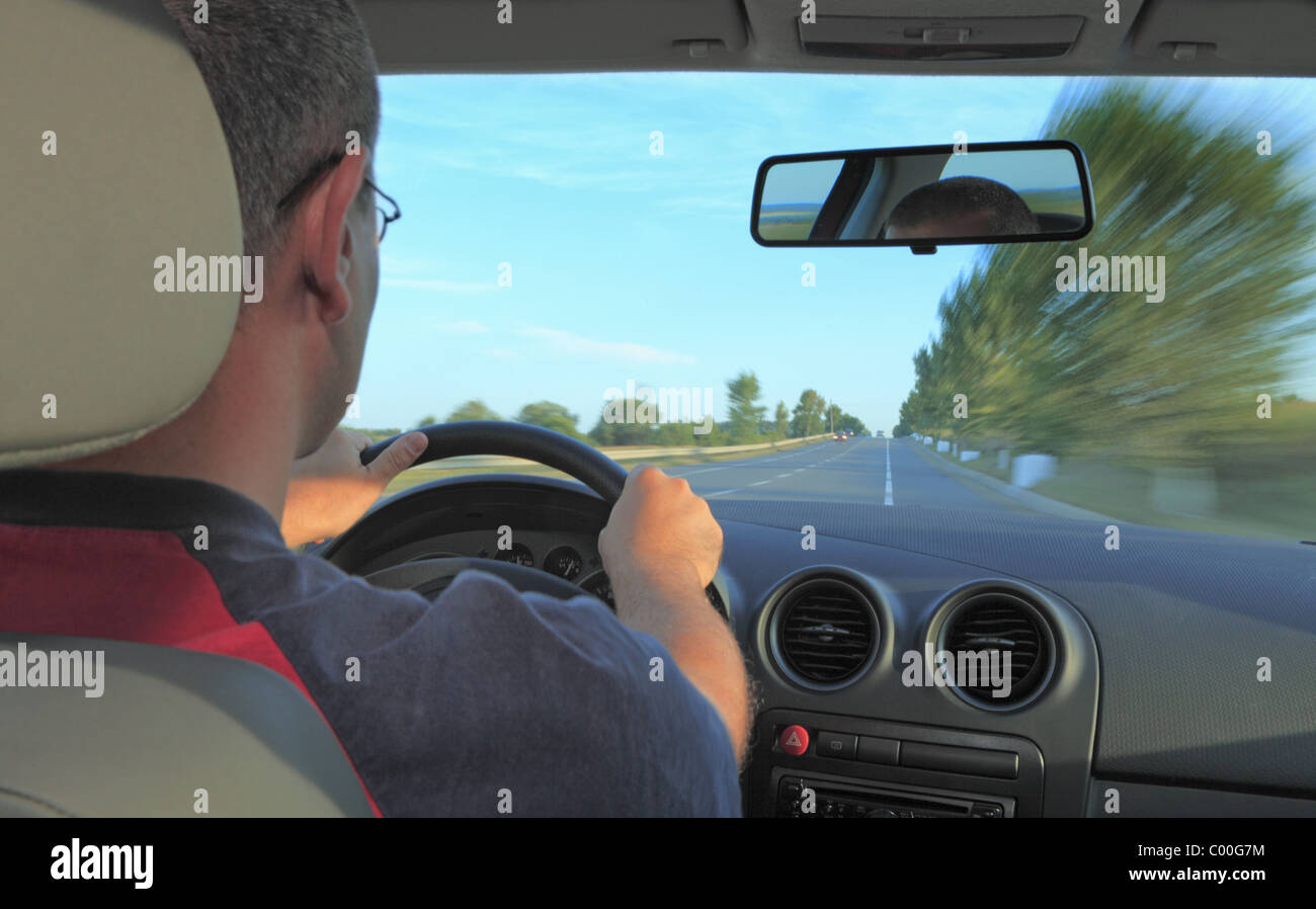 Interior car image of a man driving.Main focus is on the board Stock ...