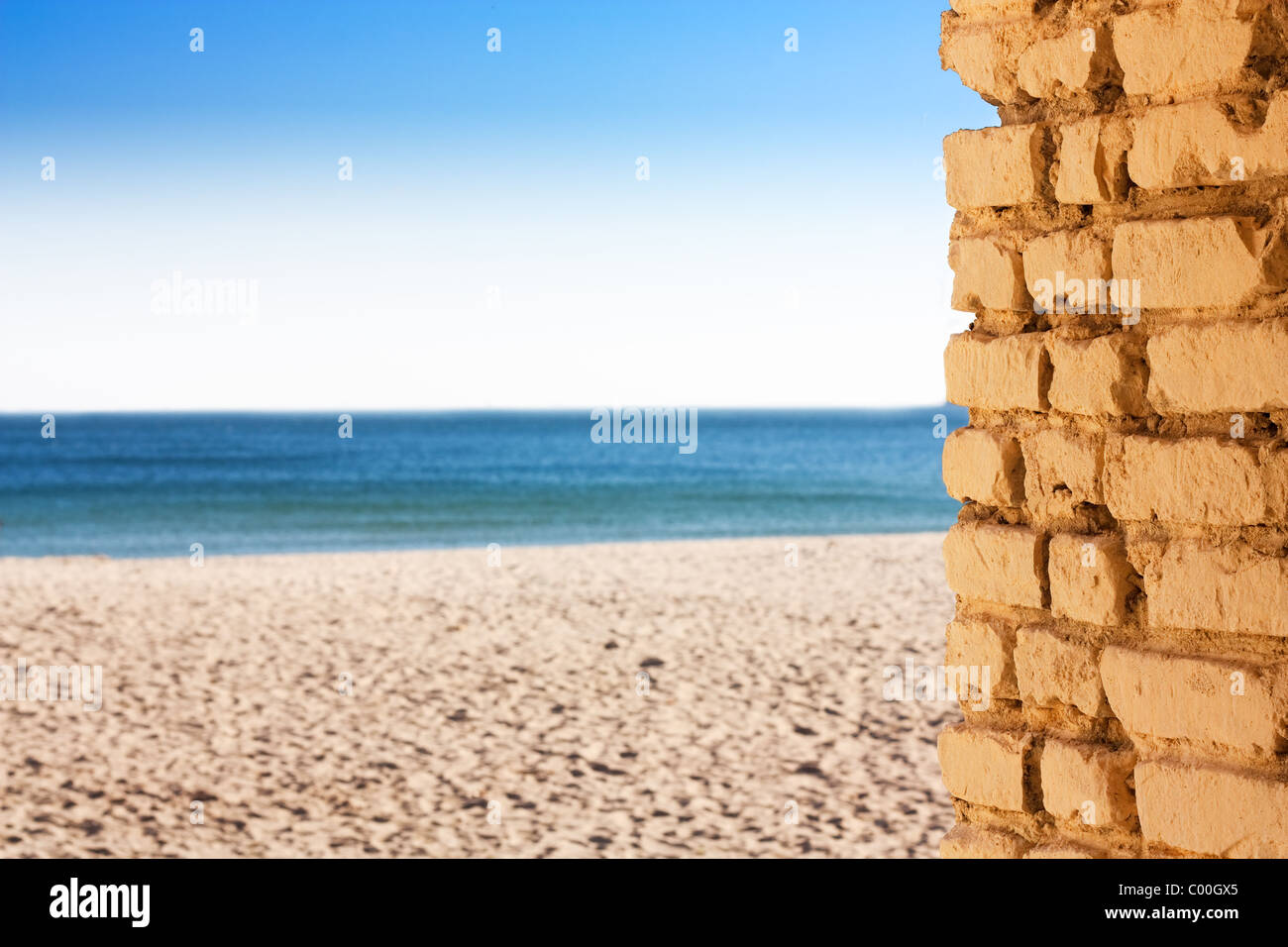 Brick wall in front of a beautiful beach Stock Photo - Alamy
