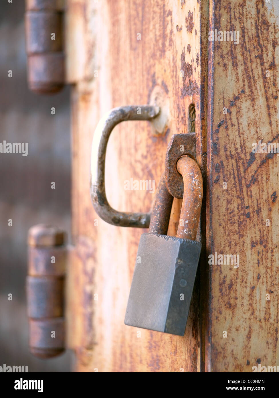 Rusty old padlock on an iron door Stock Photo - Alamy