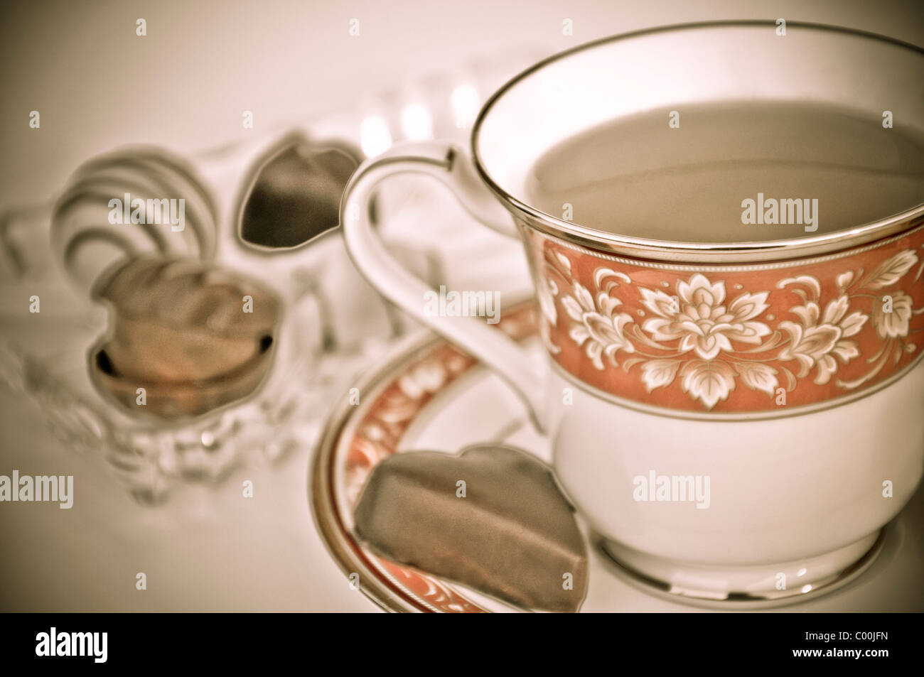 Classy porcelain cup of tea and chocolates - vintage abstract look ...