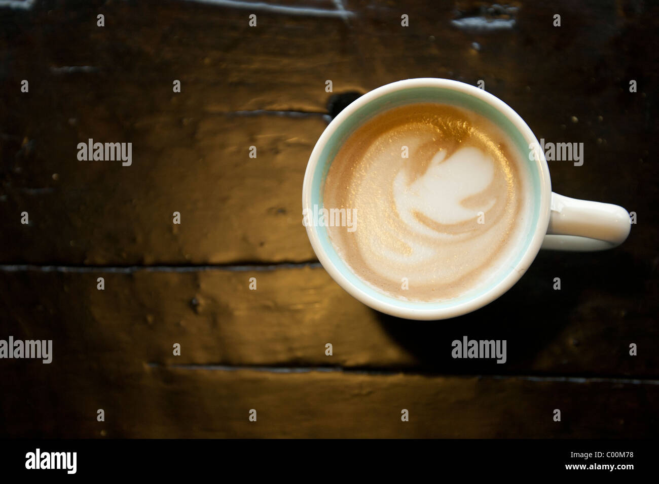 Cappuccino in a teal coffee cup Stock Photo - Alamy